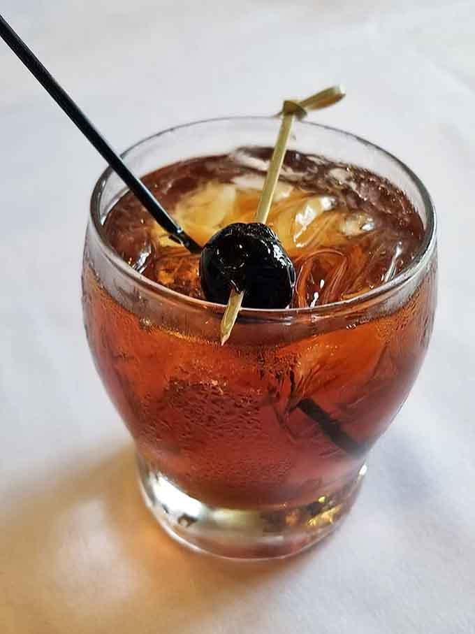 A classic Manhattan with that perfect cherry garnish proves they take their cocktails as seriously as beer.