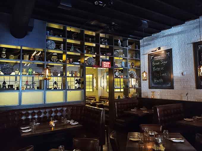 Leather booths, backlit shelving, and thoughtful design create a space that feels both upscale and genuinely welcoming throughout.