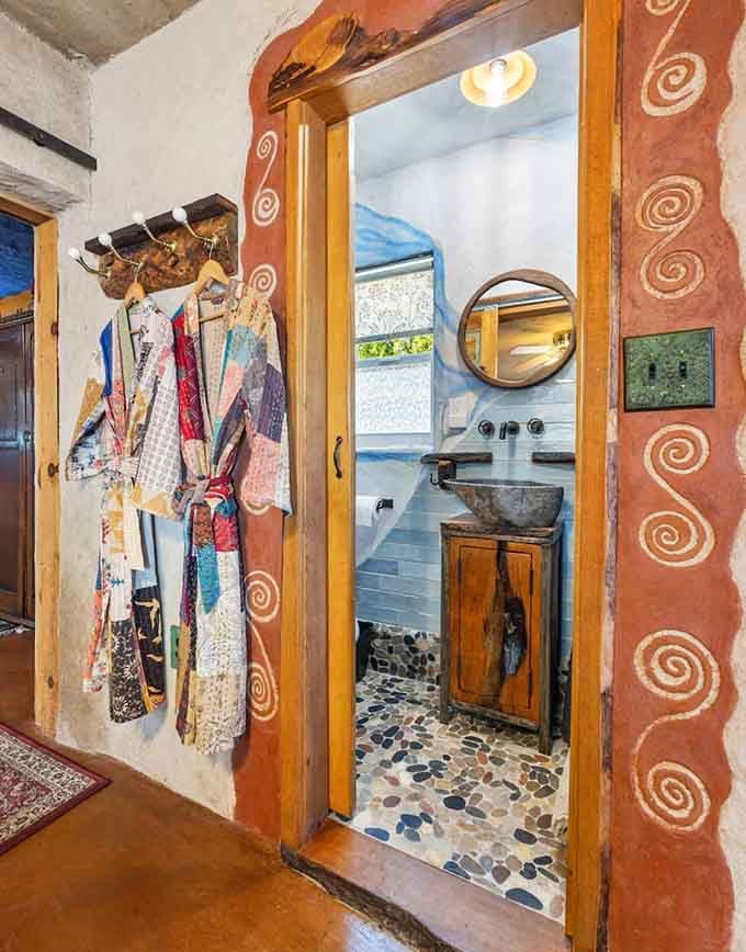 Even the bathroom entrance gets the hobbit treatment with decorative archways and earthy tones.