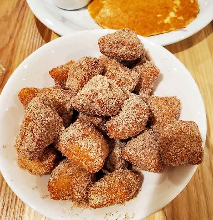 Cinnamon sugar puffed dough that looks like edible clouds dusted with sweet, spicy happiness all over.