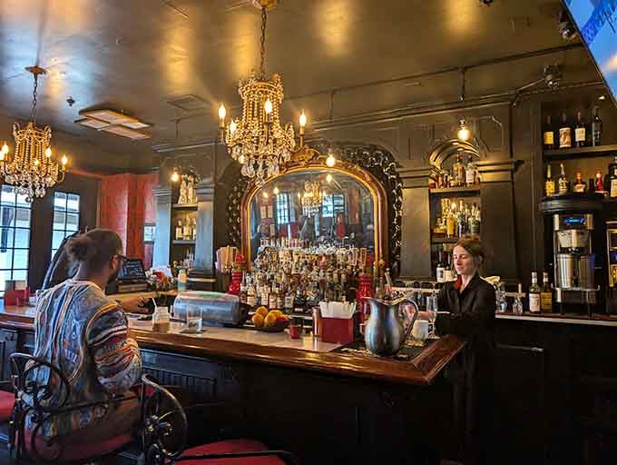 Crystal chandeliers and bourbon bottles living together in perfect harmony, proving elegance doesn't require stuffiness at all.