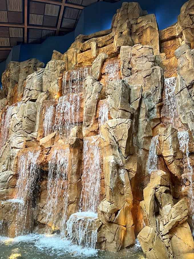 Multiple streams cascade down textured stone, creating nature's most impressive dinner soundtrack you'll hear indoors.