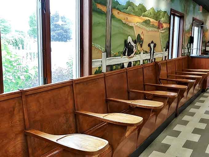 Wooden booth seating with pastoral murals creates a cozy farmhouse vibe perfect for savoring every last spoonful slowly.