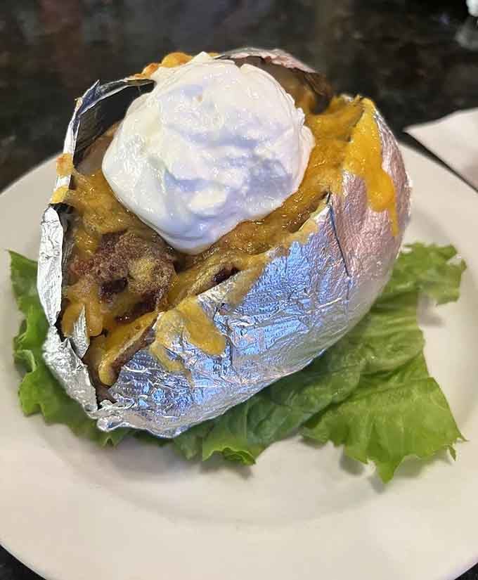 A loaded baked potato so stuffed with toppings it needs its own area code and possibly structural support.