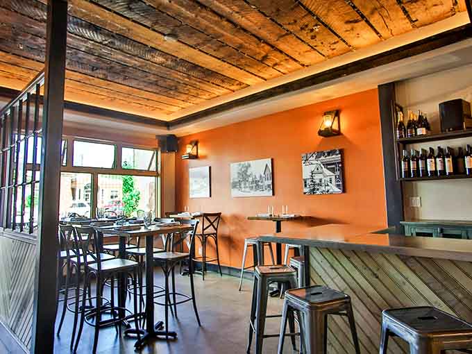 Warm lighting and cozy booths with rustic wood beams overhead make every meal feel like a special occasion here.