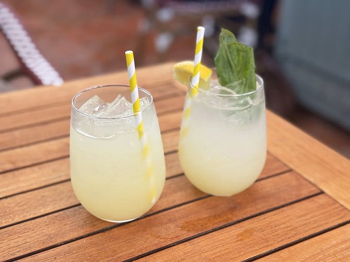 Fresh lemonade in stemless glasses with striped straws, because hydration should be as thoughtful as everything else on the menu.