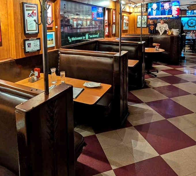 Dark leather booths and wood paneling create intimate spaces where families have gathered for generations of meals.