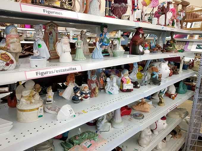 Figurines and collectibles lined up like a porcelain army, each one somebody's former treasure waiting for rediscovery.