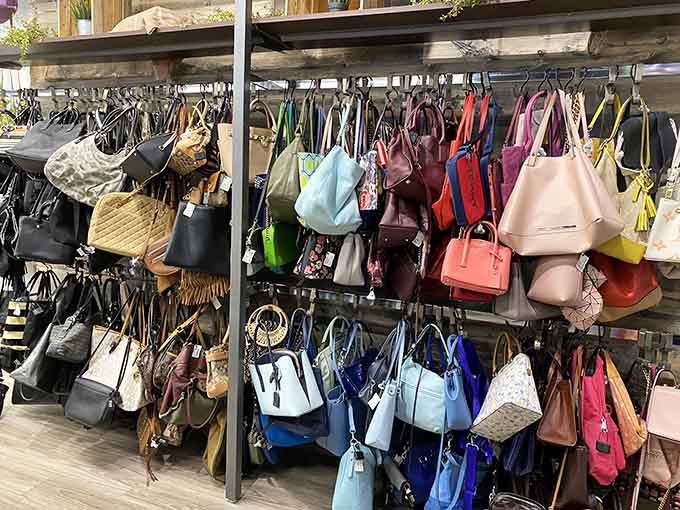 Handbag wall of fame, displaying purses in every color from practical black to "look at me" pink.