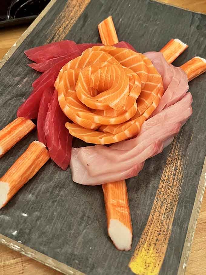 Sashimi arranged like edible art, because presentation matters even when you're drinking in a comic book vault.