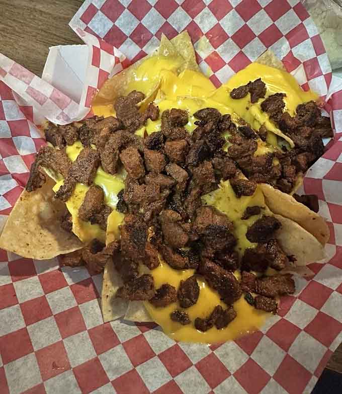 Loaded nachos with carne asada and melted cheese, because Italian-themed steakhouses can do Mexican too.