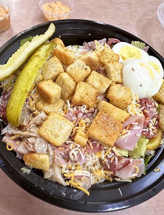 The Cobb salad arrives loaded with croutons, hard-boiled egg, and enough toppings to qualify as a full meal.