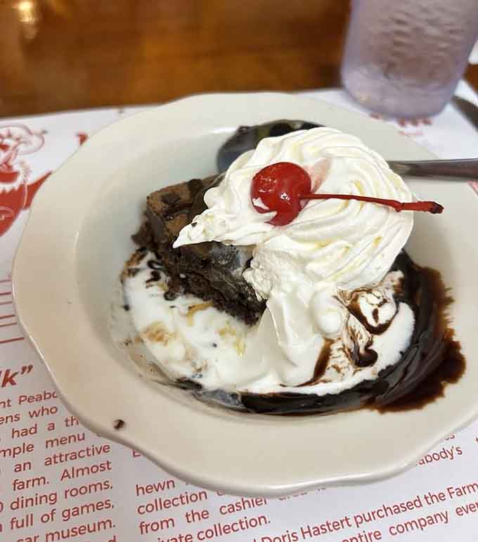 This brownie sundae topped with whipped cream and a cherry finishes what the chicken started, deliciously and unapologetically.