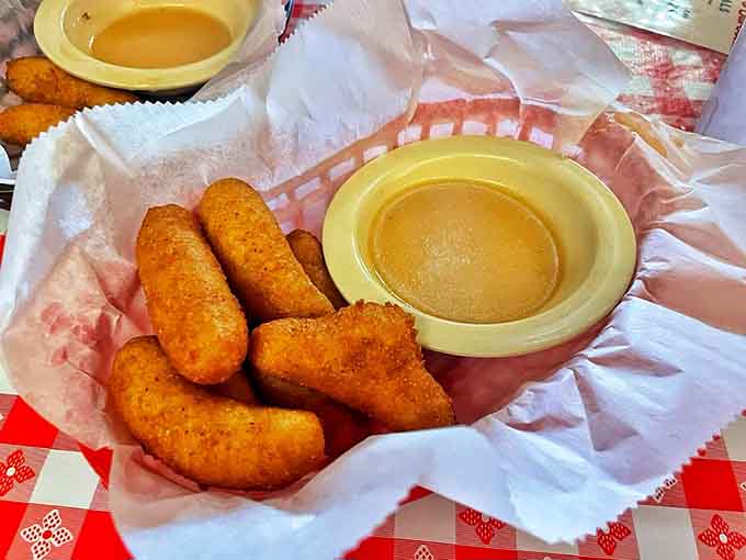 Golden hush puppies that could make a vegetarian reconsider their life choices, crispy outside and tender within.