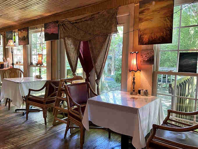 String lights, local art, and windows overlooking the gardens. Dining rooms should always feel this welcoming and warm.
