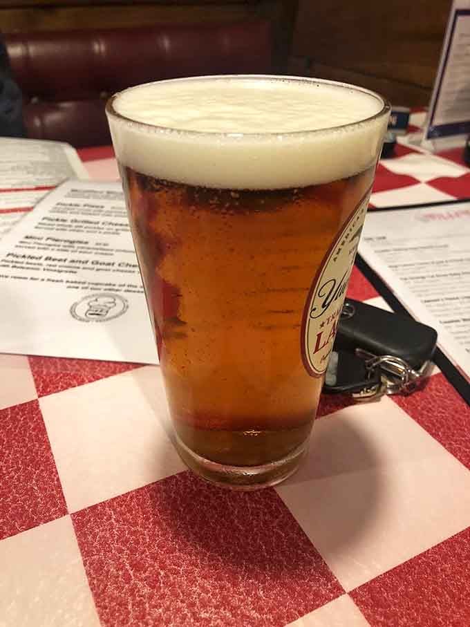 A perfectly poured beer with a proper head pairs beautifully with pizza that deserves your full attention.