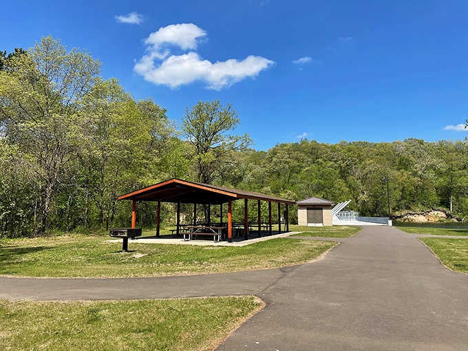 A covered shelter where families gather, proving that the best memories often happen around simple picnic tables.