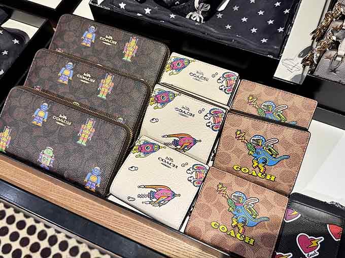 Coach wallets featuring playful designs that'll make you smile every time you reach for your credit card, which will be often.