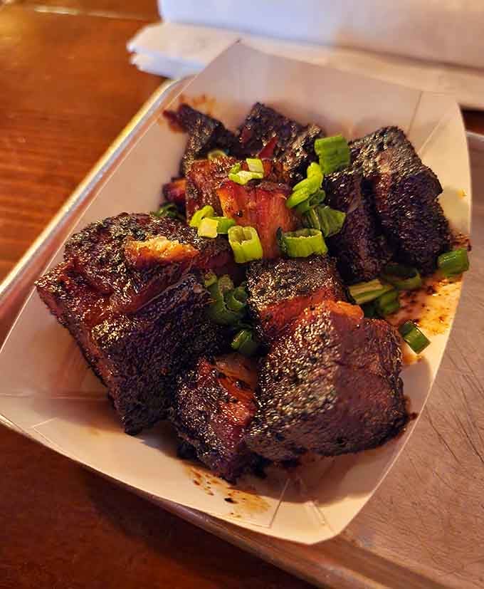 Burnt ends topped with scallions represent the holy grail of barbecue, those flavorful nuggets everyone fights over.