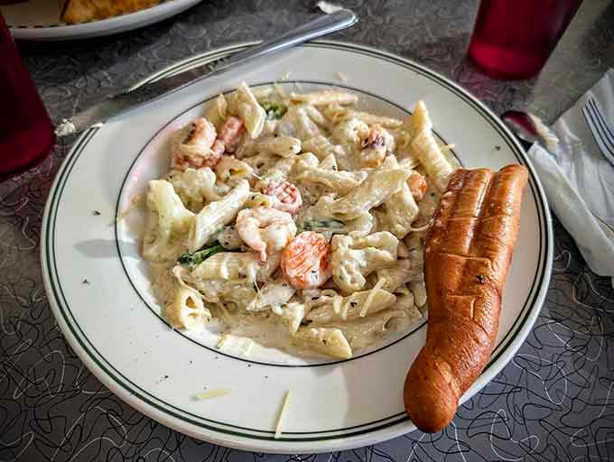 Shrimp Alfredo pasta proves this diner menu goes beyond burgers, delivering creamy comfort in every twirl of your fork.