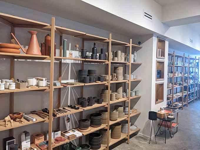 Handcrafted ceramics displayed like treasures in a museum, reminding us that everyday objects deserve to be beautiful too.