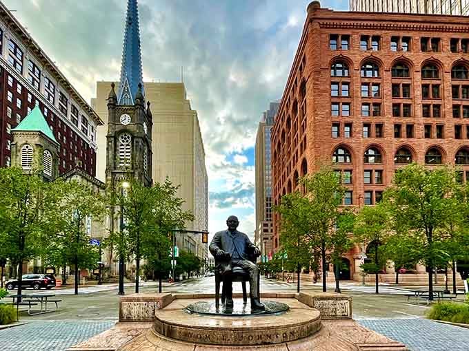 That seated bronze figure watches over downtown like a patient grandfather, surrounded by century-old brick and modern glass.