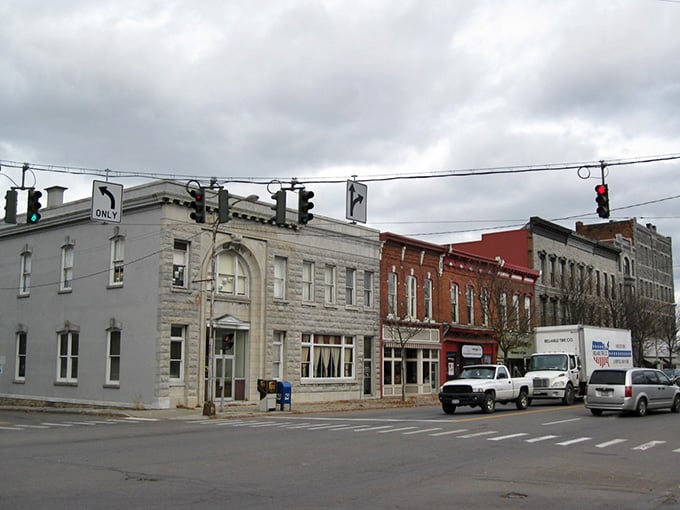 Historic brick buildings wear their age proudly, each facade telling stories of generations who built businesses and lives in this place.