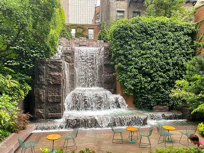 A waterfall cascades down granite in the heart of Midtown, proving tranquility exists even among the chaos.