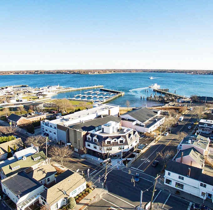 The harbor spreads out in shades of blue, with boats dotting the water like toys in a bathtub for grown-ups.