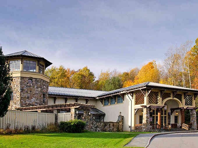 This rustic stone and timber building blends beautifully with autumn foliage, showing Jamestown's architectural charm throughout every season.