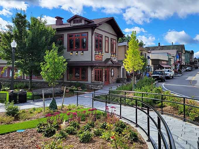 Alpine-style architecture nestled against mountain slopes creates a Swiss village atmosphere that's pure Adirondack magic with European flair.