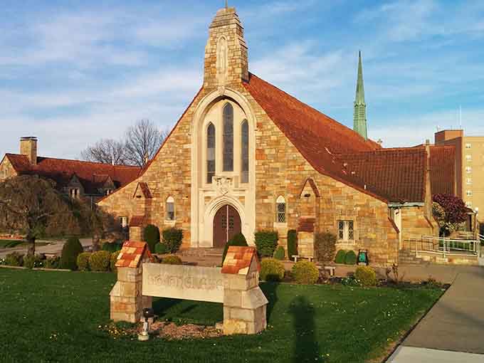 Honey-colored stone and Gothic details make this church look like it was transported straight from the English countryside, chimney and all.