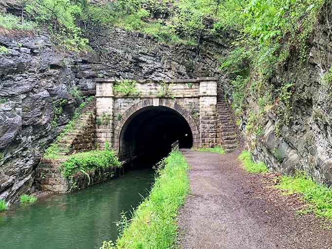 This stone archway marks the entrance to a hand-carved tunnel that took years of dangerous labor to complete through solid rock.