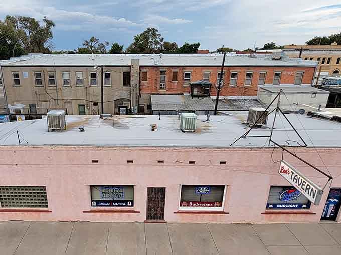 The rooftop view reveals layers of history, where old tavern signs hint at countless conversations shared over cold drinks.