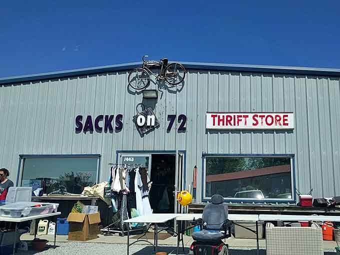 A vintage bicycle sculpture crowns this quirky shop where outdoor displays spill treasures onto tables like a yard sale.