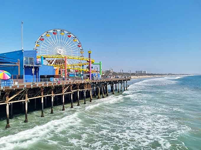 The iconic Ferris wheel spins its rainbow of colors above the Pacific, creating California's most recognizable seaside celebration.