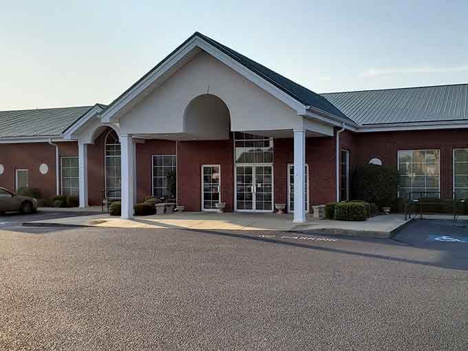 The elegant brick entrance with white columns suggests Southern hospitality meets serious steakhouse tradition in perfect harmony.