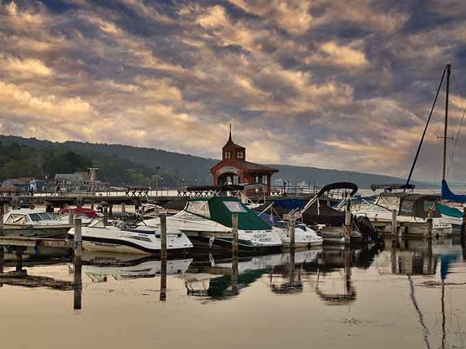 Boats bob peacefully in the marina while dramatic clouds paint the sky in shades that photographers dream about.