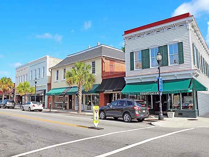 Palm trees sway beside pastel buildings with green awnings, creating a coastal scene that could grace any Southern Living cover.