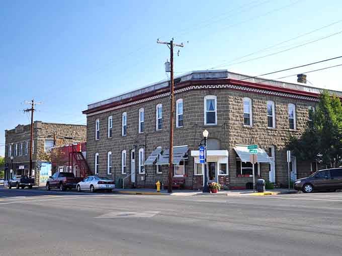 Solid stone construction speaks to pioneer determination in this corner building that's weathered over a century proudly.