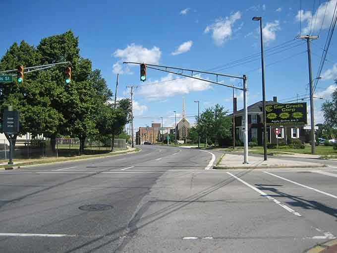 Wide streets and green spaces frame a church steeple, reminding us that some towns still value breathing room.