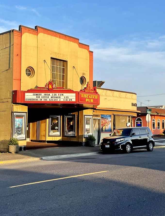 That Art Deco theater marquee glows like a beacon, proving small-town entertainment venues still know how to make an entrance.