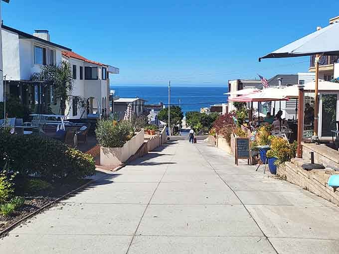 Potted plants and American flags add homey touches to this breezy walkway where ocean views await around every corner.