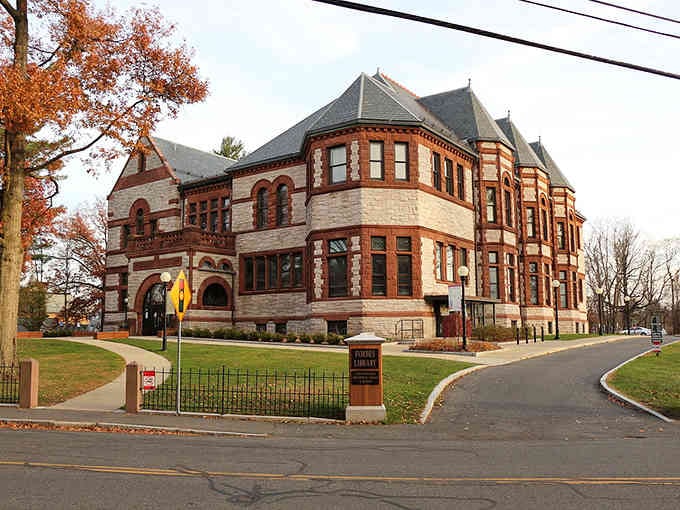 Romanesque architecture with turrets and arched windows creates a castle-like presence that dominates this historic corner.