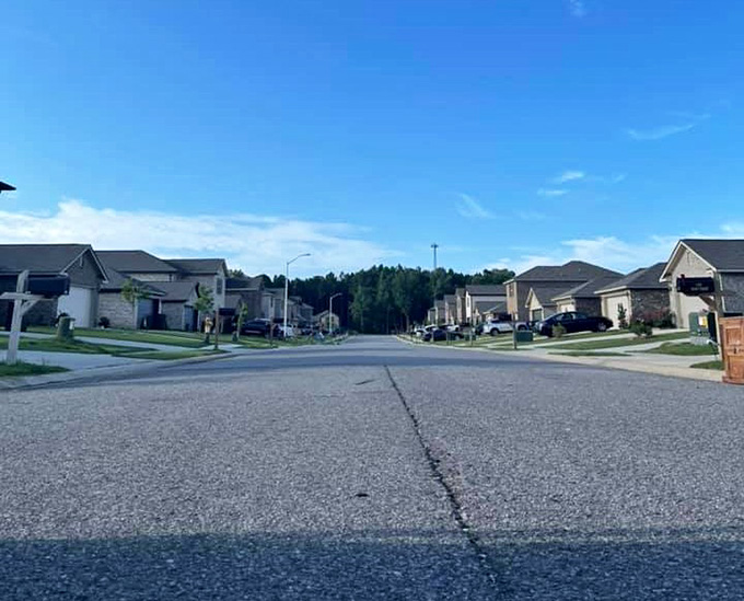 Modern suburban streets curve through neighborhoods where lawns stay green and neighbors still wave from their driveways every morning.