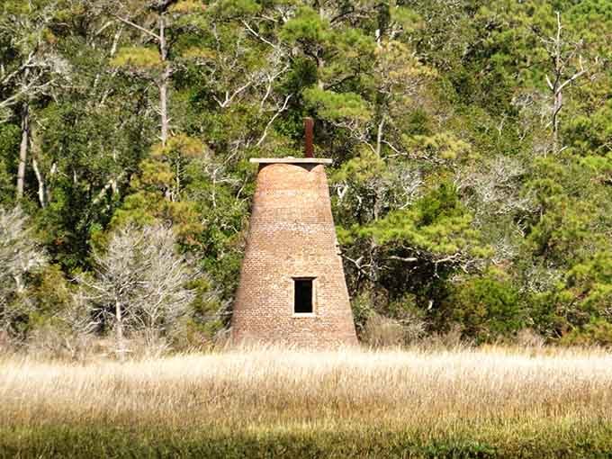 Nature slowly reclaims this mysterious brick tower, creating a hauntingly beautiful blend of human ambition and natural persistence.