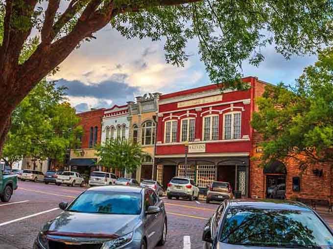 Red brick storefronts catch the evening light beautifully, creating a Main Street scene that Norman Rockwell would recognize.