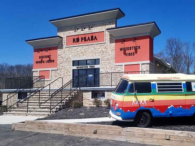 Coral-colored signs and stone facade create an inviting plaza atmosphere where thrifting feels like a special outing, not a chore.