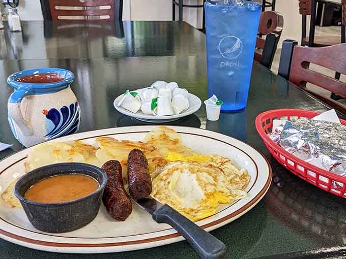 Eggs, sausage, and home fries create the holy trinity of breakfast comfort on one perfect plate.