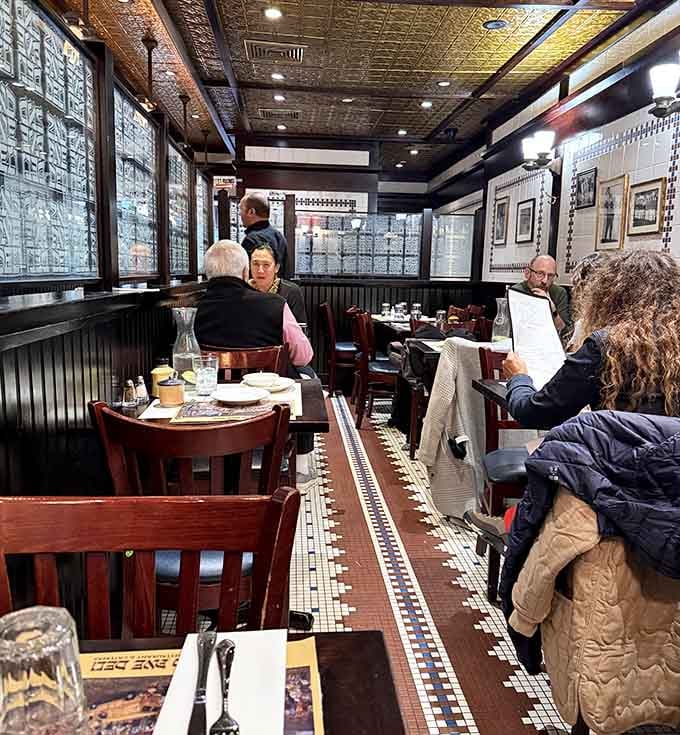 The dining room hums with happy eaters, all united in their quest to conquer impossibly overstuffed sandwiches.